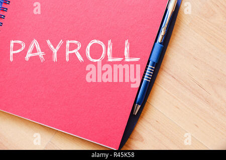 Payroll write on notebook Stock Photo - Alamy