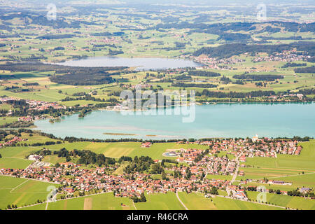 Aerial view over Lake Forggensee at the city of Fuessen in Germany ...