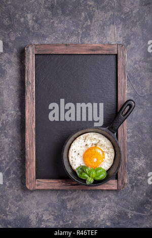 Egg on a wooden background. Chalk-drawn ears and a painted muzzle. Top ...