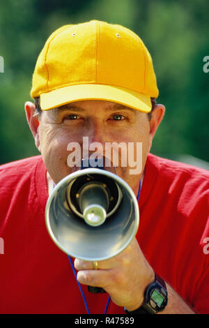 Male coach using megaphone Stock Photo - Alamy