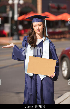 Young student begging with blank cardboard sign Stock Photo - Alamy