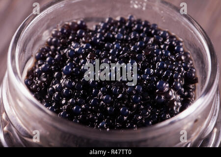red lumpfish roe in a glass jar and a hand holding a spoon Stock Photo ...