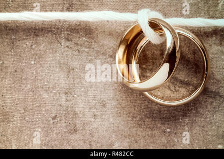 Golden rings hanging on rope Stock Photo - Alamy
