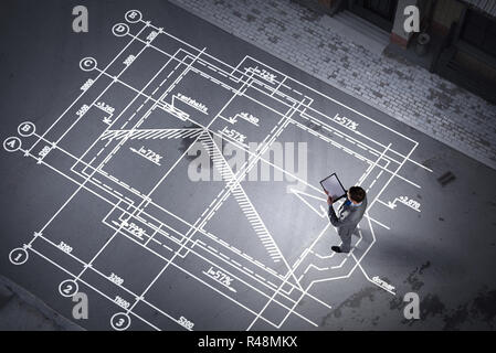 Man engineer thinking over his plan. Mixed media Stock Photo - Alamy