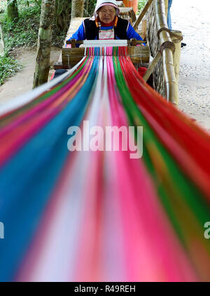 woman weaves using a traditional loom, people of Palaung tribe, Kalaw ...