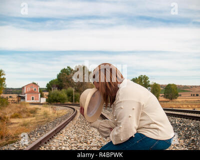 a sad girl on railway tracks Stock Photo - Alamy