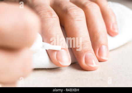 Spa concept. Hand applying nourishing scrub on female face in spa salon ...