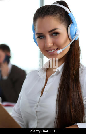 Beautiful brunette smiling call centre clerk at work Stock Photo - Alamy