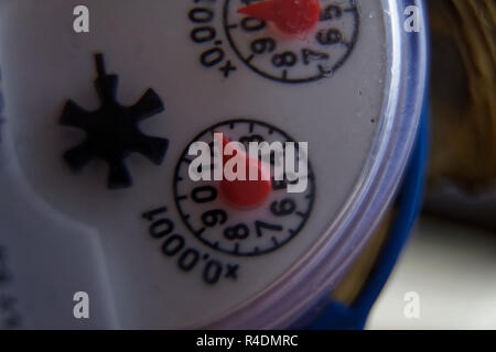 Water meter close-up. Measurement of water flow with direction arrow ...