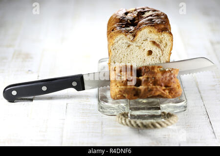 Frisian Suikerbrood (sugar bread) with knife and wooden plate isolated ...