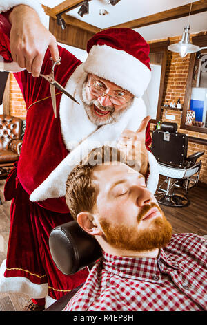 Santa claus as master at barber shop Stock Photo - Alamy