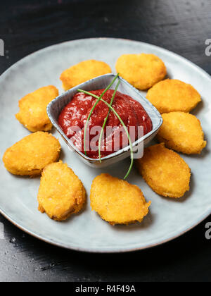 Soy nuggets on a plate, served with a spicy tomato dip Stock Photo - Alamy