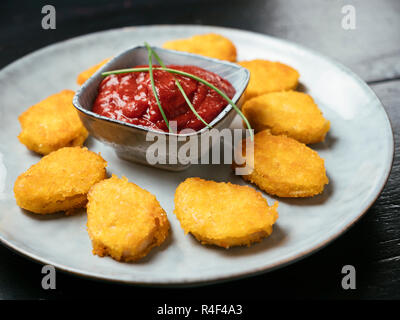 Soy nuggets on a plate, served with a spicy tomato dip Stock Photo - Alamy