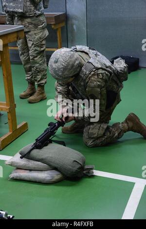 US Navy Sgt. adjusts the sight of his sniper rifle during training ...