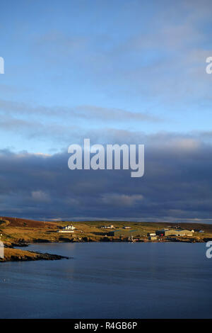 Low winter light in Hoswick Sandwick Shetland with homes around the ...