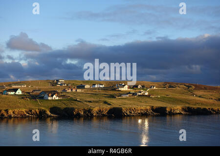 Low winter light in Hoswick Sandwick Shetland with homes around the ...