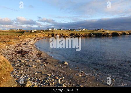 Low winter light in Hoswick Sandwick Shetland with homes around the ...