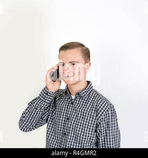 smart smiling boy uses his mobile phone Stock Photo - Alamy