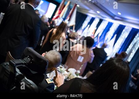 Army Capt. Luis Avila, a combat wounded service member, sings God Bless ...