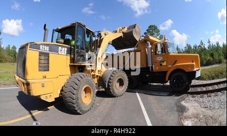 A high rail rotary dump truck from Civil Works Contracting, (CWC) dumps ...