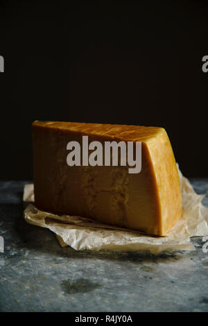 A block of parmesan cheese on metallic surface Stock Photo - Alamy