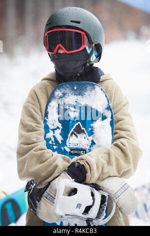 Young snowboarder wearing ski helmet descending ski slope in winter Stock Photo: 77616029 - Alamy