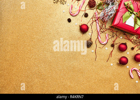Beautiful christmas red deco baubles with gifts on golden glitter ...