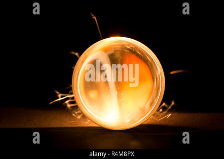 Burning sparkler behind a glass ball on a black background Stock Photo ...