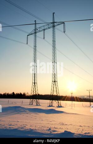 Snowy field with trees and power lines on a winter day Stock Photo - Alamy