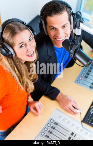 Presenters or moderators - man and woman - in radio station hosting ...