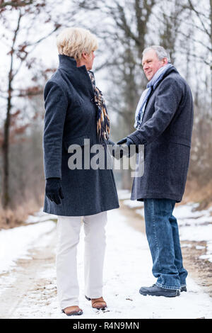 Couple saying goodbye to senior woman Stock Photo - Alamy