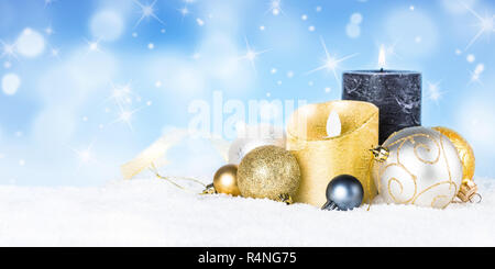 Blue Christmas ball with long ribbon over wooden yellow background ...