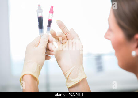 Woman doctor checking blood samples in lab Stock Photo - Alamy