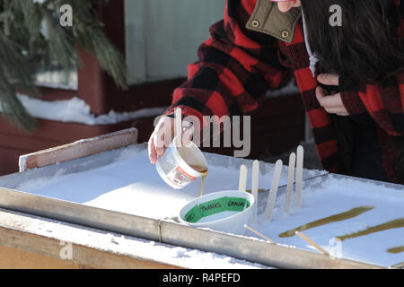 A French Canadian pouring Maple Taffy in Old Quebec, Canada Stock Photo ...
