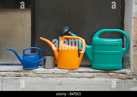Set with watering cans and different gardening tools on white ...