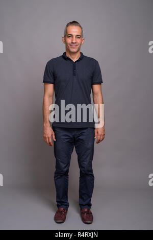 Full body shot of handsome Persian businessman listening to music Stock ...