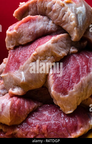 Pieces of raw diced beef fillet meat. Black background. Top view Stock ...