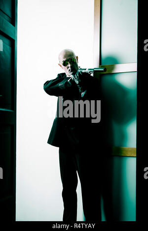 Spy man, profile and gun with suit for undercover mission, justice or ...