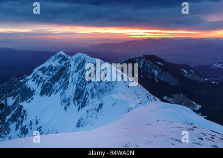 Stunning winter moonlight mountains landscape and the citylights in the ...