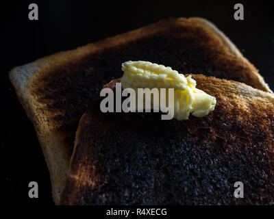Burnt toast with buter Stock Photo - Alamy