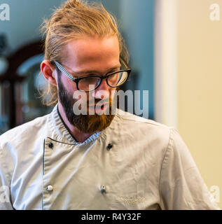 Happy young hipster man thinking while using phone Stock Photo - Alamy