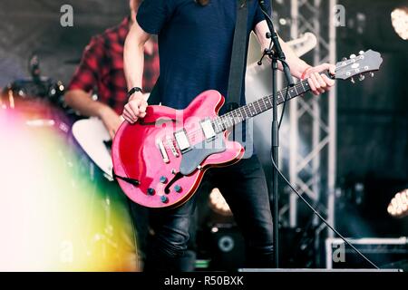 Rock band fronted by heavy metal singer with his top off showing his ...
