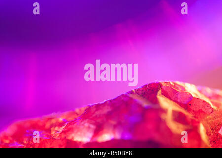 Pink Quartz crystal specimen shot using beautiful colourful lighting ...