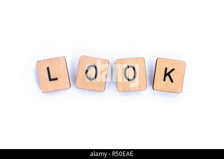 The word LOOK, spelt with wooden letter tiles over a plain white ...