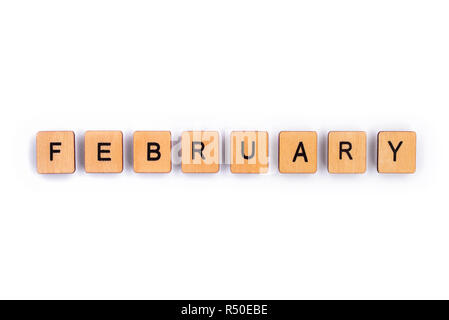 FEBRUARY, spelt with wooden letter tiles over a plain white background ...