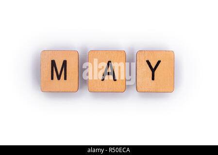 MAY, spelt with wooden letter tiles over a plain white background Stock ...