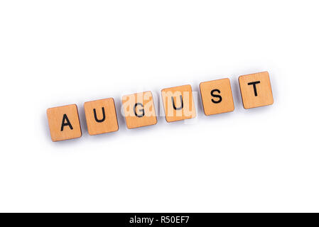 AUGUST, spelt with wooden letter tiles over a plain white background ...
