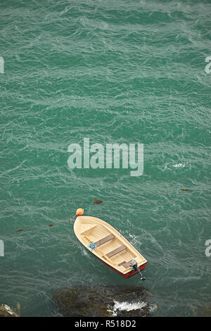 Norwegian landscape. Small motor boat stands moored near floating pier ...