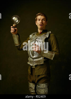 Portrait of surprised man, medieval warrior or archer in armor hiding ...