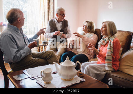 A couple relaxing over a pot of tea at the tea garden next to the ...